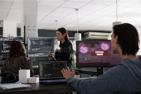 It Engineer Looking At Monitor Reading Critical Error In It Big Data
