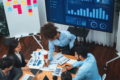 Young African Businesswoman Presenting Data Analysis Dashboard On Tv
