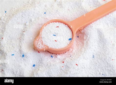 A Pile Of Washing Powder And A Measuring Spoon Powder With Blue And