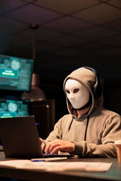 Premium Photo Masked Scammer Hacking Computer Network At Night
