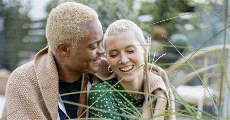 정원에서 유럽 여자 친구를 껴안고 있는 라틴 남자 함께 시간을 즐기는 즐거운 다인종 커플 관계의 개념 현대 국내 생활 방식 격자 무늬로 덮인 사람들 사진