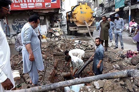Workers From The Mcs Are Utilizing Machines To Clear Obstructed Sewage While Performing Their