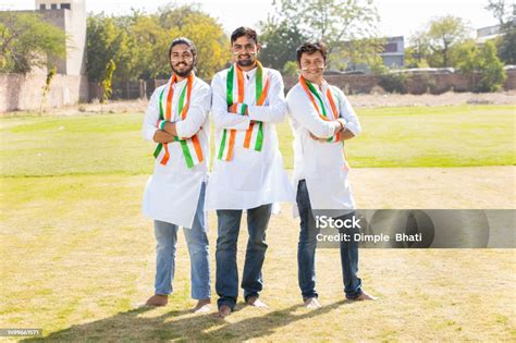 전통적인 흰색 쿠르타와 삼색 두파타를 입은 젊은 인도 남성의 그룹 초상화는 공원에서 팔짱을 끼고 서 있다 선거와 정치 독립 기념일 또는 공화국의 날을 축하합니다 전체 길이