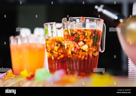 Jugs Containing Alcoholic Fresh Fruit Punch To Be Served For Guests