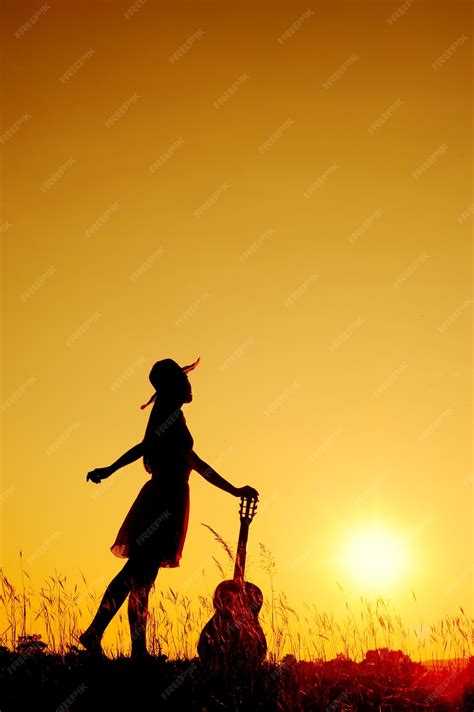 Premium Photo Woman And Guitar With Sunset Silhouette