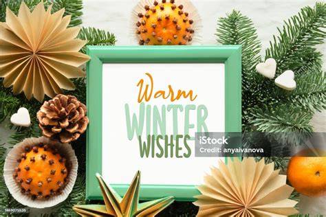 향기로운 포맨더 공 정향과 감귤로 손수 만든 갈색 종이에서 만든 수제 종이 별 전나무 나뭇 가지가있는 흰색 직물에 평평하게 누워 있습니다 인사말 텍스트 따뜻한 겨울 소원