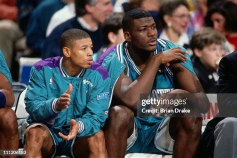 Muggsy Bogues And Larry Johnson Of The Charlotte Hornets Sit On The