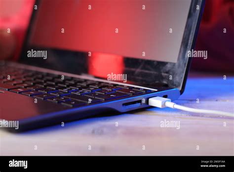 Inserting Usb Cable Into Laptop On Table And Colored Background Stock Photo Alamy