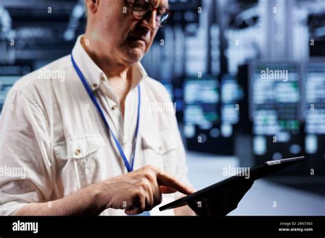 Senior Supervisor Inspects Operational Server Rigs In Computer Network