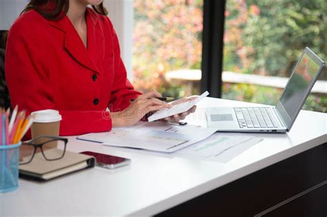Business Woman Using A Calculator To Calculate Personal Income Tax