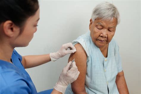 Doctor Make Injection Vaccine To Senior Woman Stock Image Image Of Health Clinic 329723543