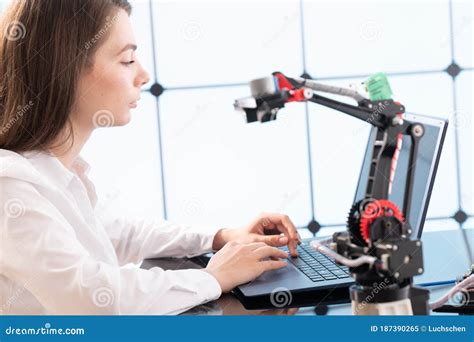 A Young Woman Writes An Algorithm For The Robot Arm Science Research Laboratory For Robotic Arm