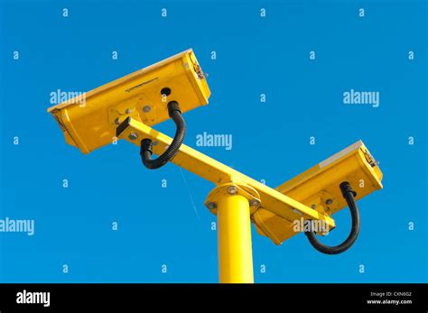 Double Surveillance Security Camera Or Cctv Against Blue Sky Stock