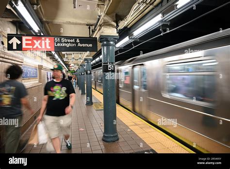 Riders Exit The Platform As A Mta Subway Train Leaves The 51st Street Station In New York City