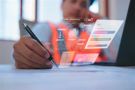 An Engineer Or Foreman Working On Site Sitting On Desk In Office Using Pen And Computer