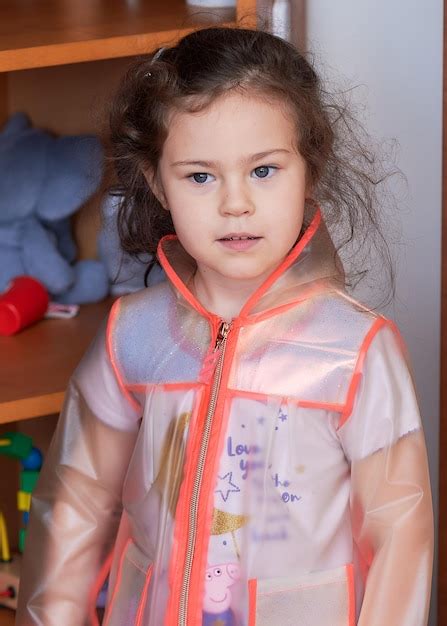 Premium Photo Cute Girl Posing In A Rain Cover In Her Room