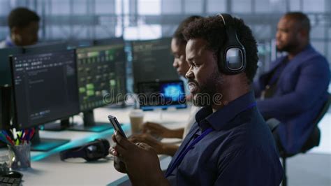 data center it expert texting on smartphone taking break stock footage