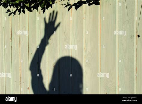 Shadow Of A Person Raising Their Hand Outside With Copy Space Concept