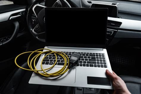 premium photo car diagnostics with laptop computer in car