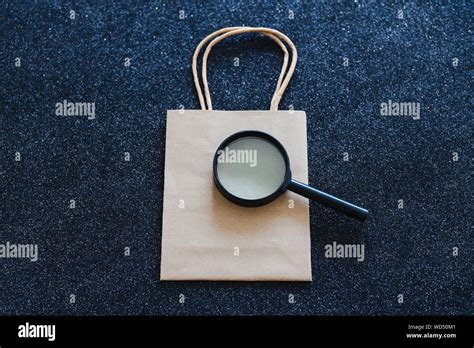 Shopping Bag And Magnifying Glass Analyzing It On Black Glitter Background Customer Spending