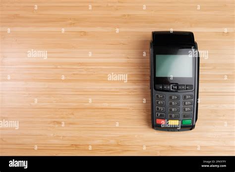 POS Terminal On The Wooden Desk With Copy Space Contactless Payment With NFC Technology Stock