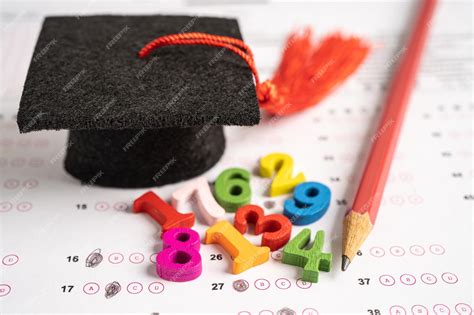 Premium Photo Graduation Gap Hat And Pencil On Answer Sheet Paper