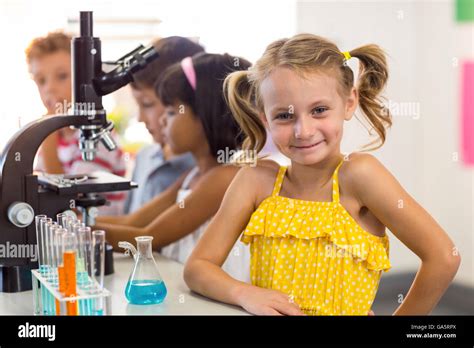 Girl With Classmates In Laboratory Stock Photo Alamy