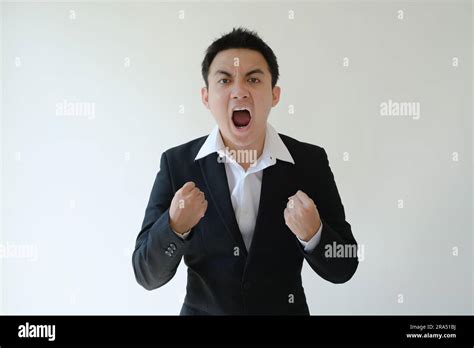 Young Asian Business Man With Excited Face Expression And Looking To