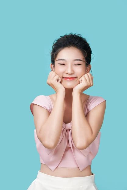 Premium Photo Portrait Of An Adorable Woman With Open Palms Near Face Having Fun Isolated On