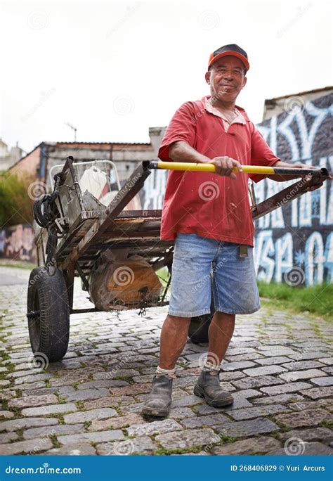 Keeping It Clean Portrait Of A Garbage Collector With His Cart In The