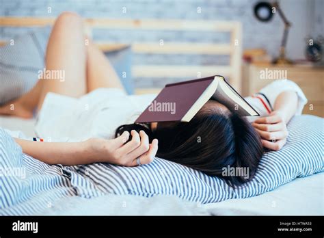 Female Teen Falls Asleep While Reading The Book Book On Top Of Her