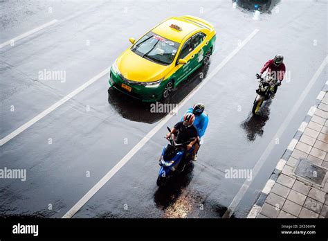 Cars Vans Buses And Motorbikes All Pass Along A Busy Intersection On
