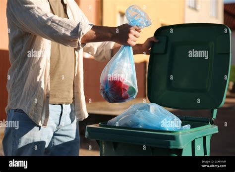 Man Throwing Trash Bag Into Bin Outdoors Closeup Stock Photo Alamy