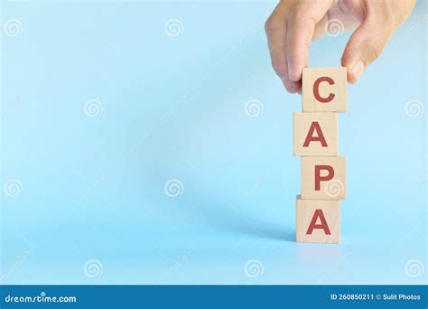 CAPA Or Corrective And Preventive Action On Wooden Blocks In Blue Background Stock Photo