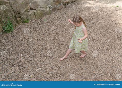 A Five Year Old Girl Walks Barefoot On Sawdust Stock Image Image Of