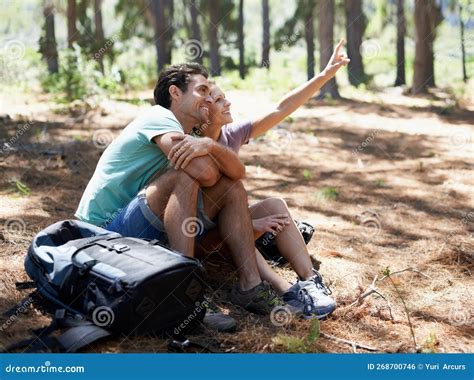 Sharing A Passion For Nature A Happy Young Couple Sitting On The