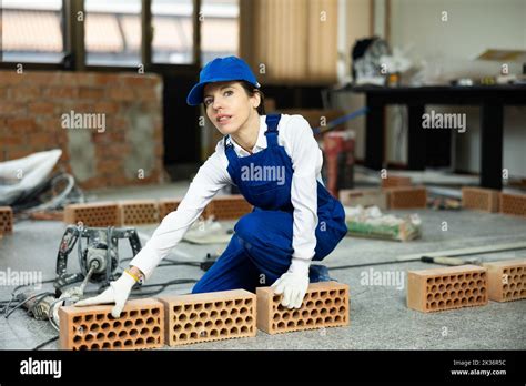Female Builder Preparing Bricks For Erection Of Partition Wall Stock Photo Alamy