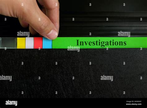 Hand Picking Investigations File Record In Black Binder Folder Crime Legal And Incident