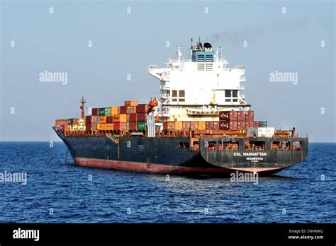 Loaded Container Vessel With Black Hull And White Superstructure Viewed