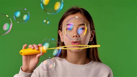 Asian Girl Blowing In Soap Bubble Stick Maker Bubbles Flying Around Positive Expression