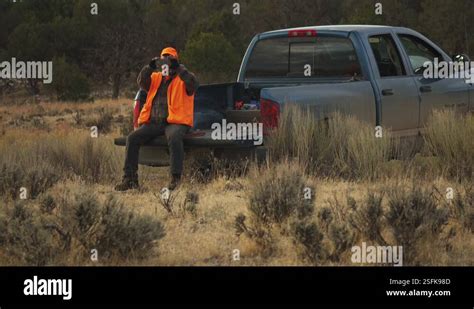 Hunter Filming How Two Men Carry A Dead Deer Buck Towards The Pick Up