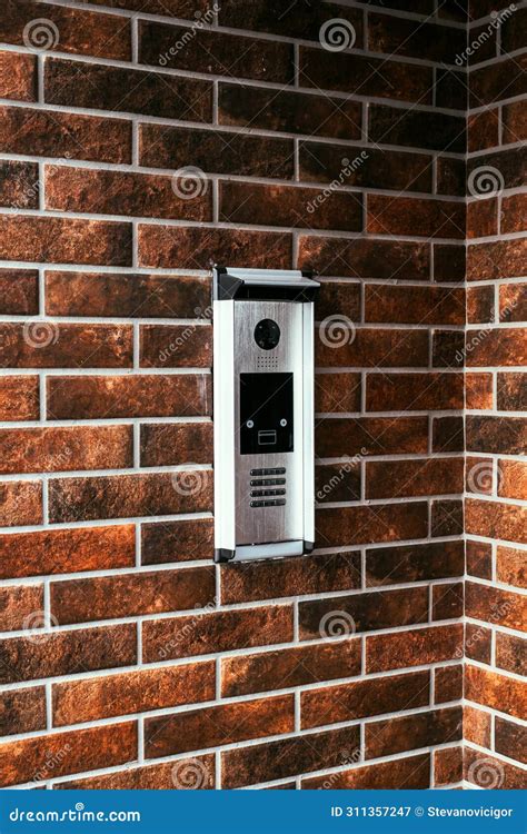 Modern Intercom Device At Residential Building Entrance Door With Camera And Dial Keypad Lock