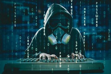 Premium Photo Hooded Male Hacker In Gas Mask Using A Computer