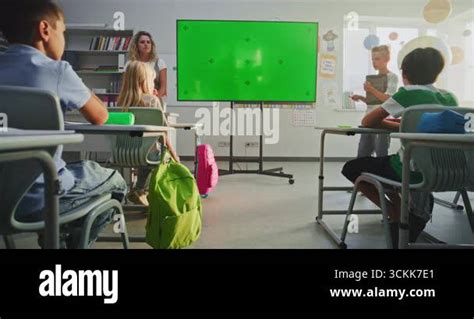 Primary School Boy With Tablet Computer Showcasing Knowledge In Front
