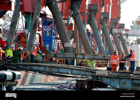 Chinese Workers Prepare The First Of Four New Container Gantries To Be Unloaded Onto The Pier At