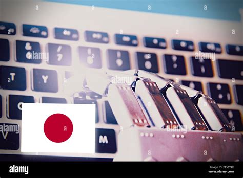 Robotic Hand Typing On A Keyboard With The Japanese Flag Concept Of