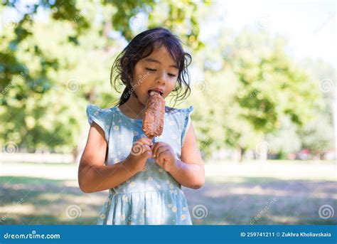 Close Up Of Nice Asian Girl Enjoying Ice Cream In Summer Park Stock