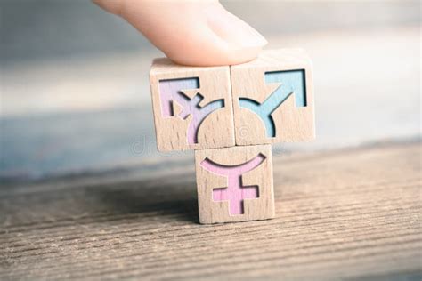 Transgender LGBT Or Intersex Icon On Wodden Blocks On A Board Arranged By A Finger Stock
