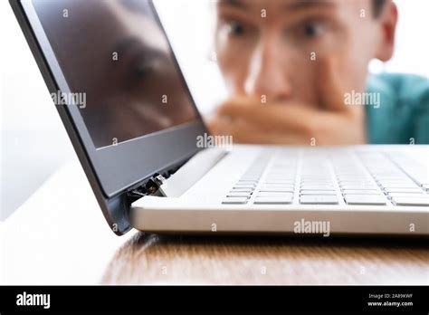 Man Looking At Damaged Laptop Computer With Broken Screen Attachment Man Looking At Damaged Laptop Computer With Broken Screen Attachment