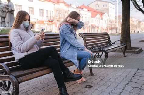 마스크에 소녀입니다 코로나 바이러스 테마 도시의 여성은 격리 기간 동안 보호 마스크없이 벤치에 앉아있다 여성 재채기 와 기침 벤치에 대한 스톡 사진 및 기타 이미지 Istock